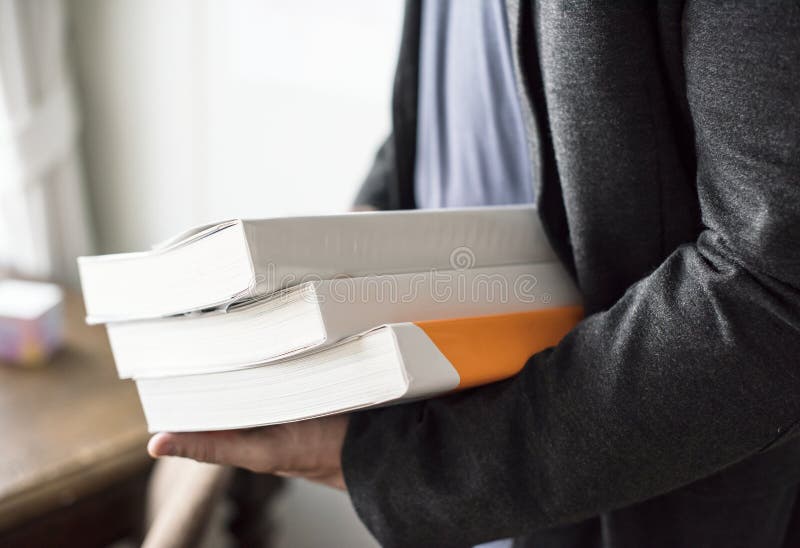 Closeup of Hands Holding Stack of Books Stock Image - Image of person ...