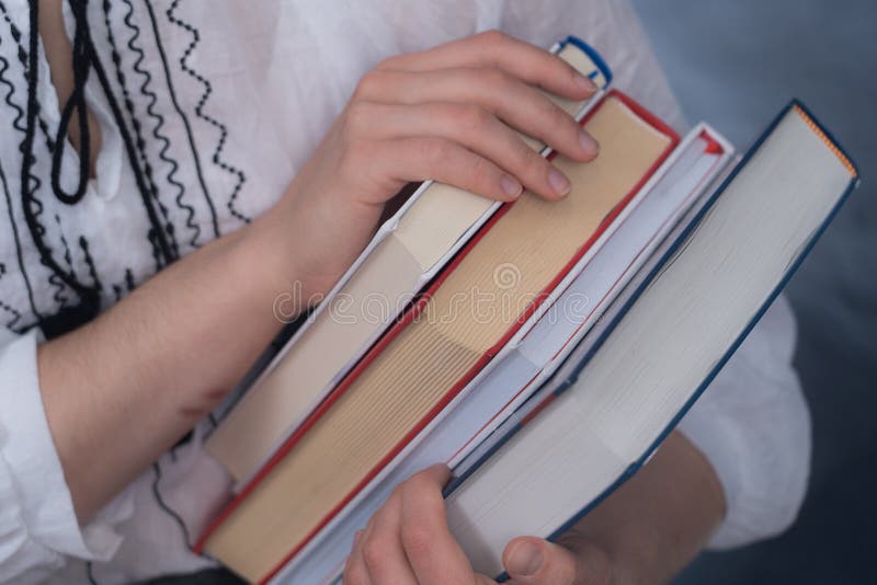 Closeup of Hands Holding a Stack of Books. Concept of Education and ...