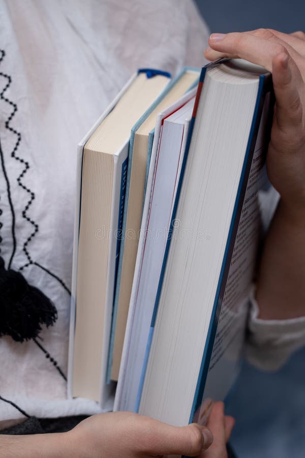 Closeup of Hands Holding a Stack of Books. Concept of Education and ...