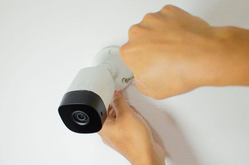 Closeup of Hands Installing a Home Security Camera on a White Wall ...