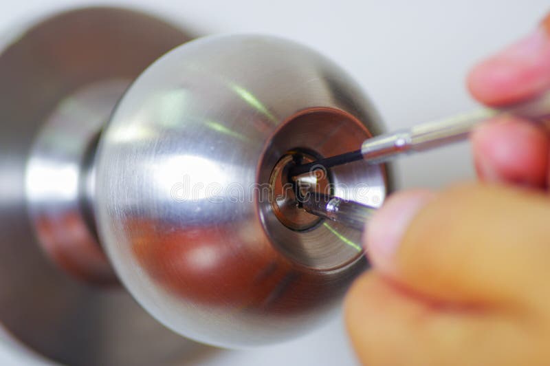 Closeup Hands of Locksmith Using Metal Pick Tools To Open Locked Door ...