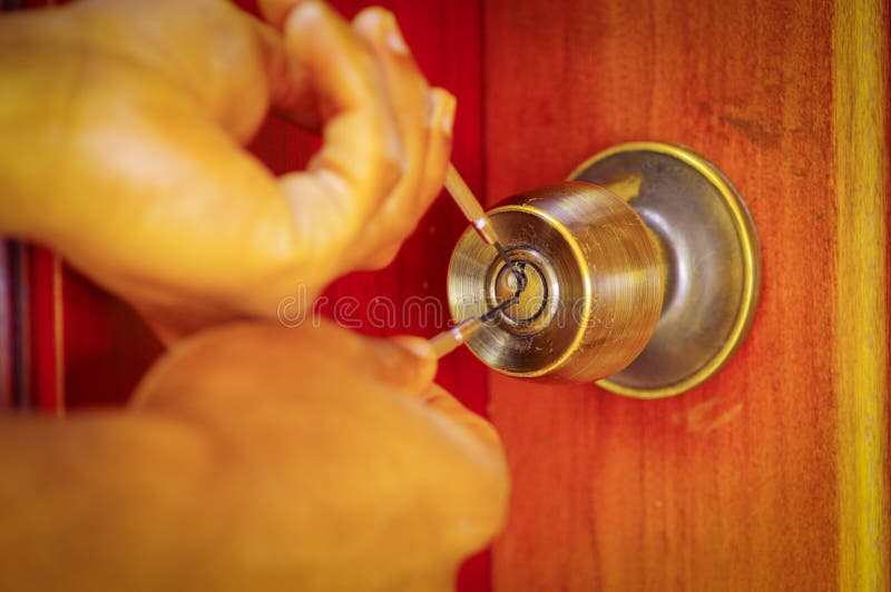 Closeup Hands of Locksmith Using Metal Pick Tools To Open Locked Door ...