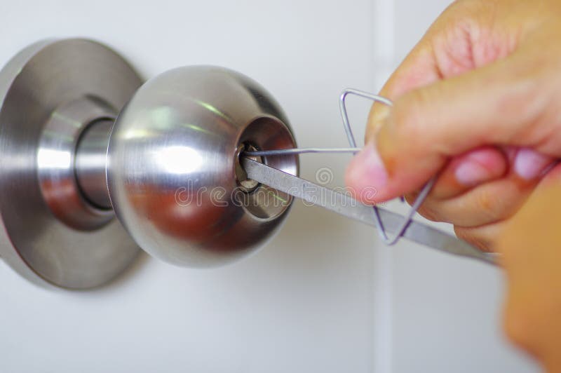 Closeup Hands of Locksmith Using Metal Pick Tools To Open Locked Door ...