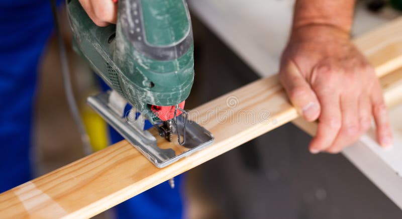 Cropped View of Man Using a Jigsaw Machine on Wooden Plank at Home ...