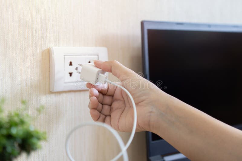 Closeup of the Hands of a Woman Plugging in or Plug of Her Smartphone ...