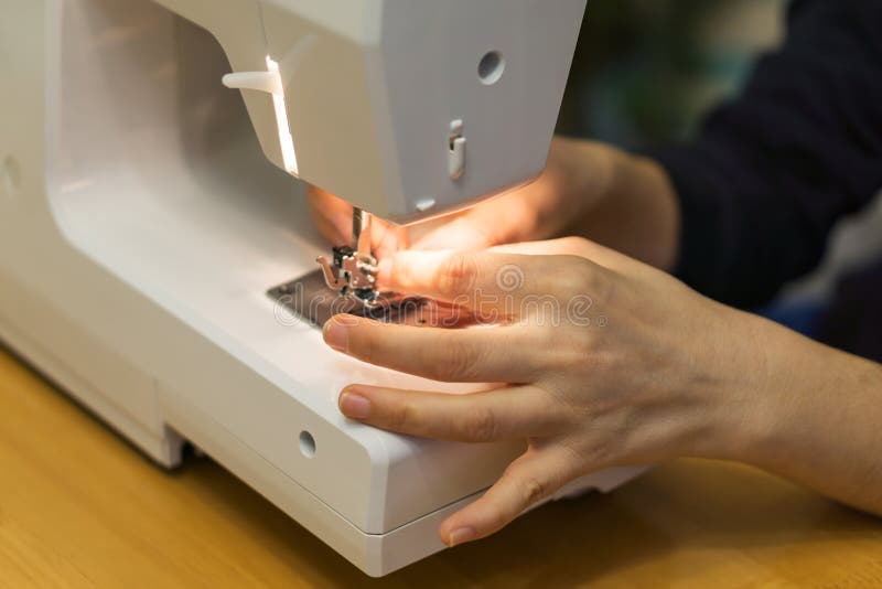 Closeup of Hands a Young Woman Spends Thread a Sewing Machine at Stock ...