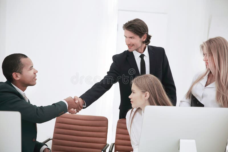 Closeup .the Handshake between Colleagues in the Workplace Stock Image ...