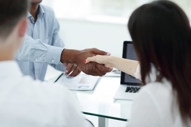 Closeup.the Handshake of Employees in the Workplace Stock Image - Image ...