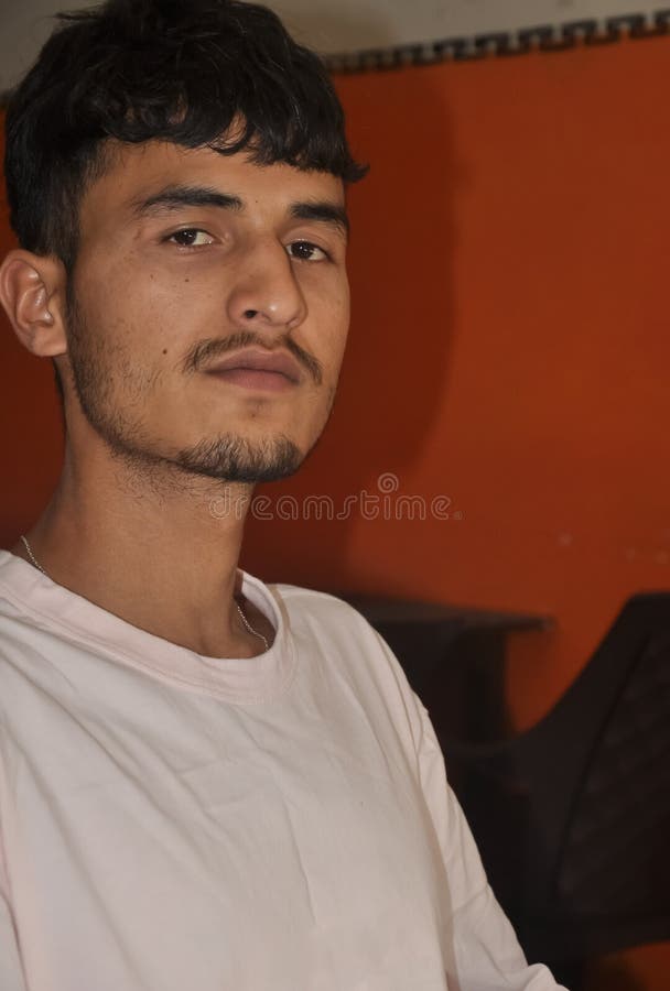 Closeup of a Handsome Indian Young Guy Sitting Indoors with Looking at ...