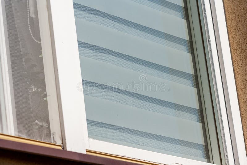 Closeup of Home Window Exterior with Daytime Night Blind and Mosquito ...