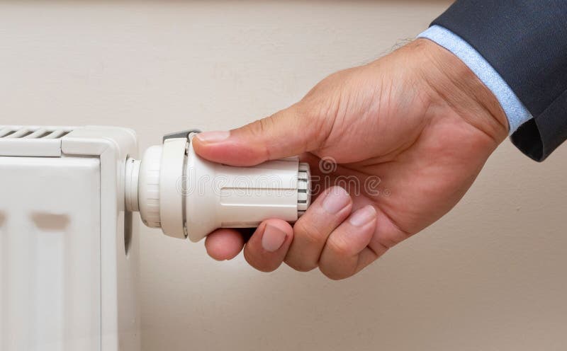 Closeup of Human Hand Adjusting the Temperature of a Radiator Stock ...