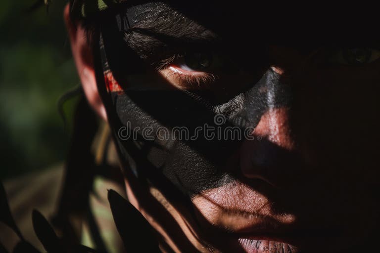 Closeup of a Hunters Face with Face Paint in the Shadows Stock ...