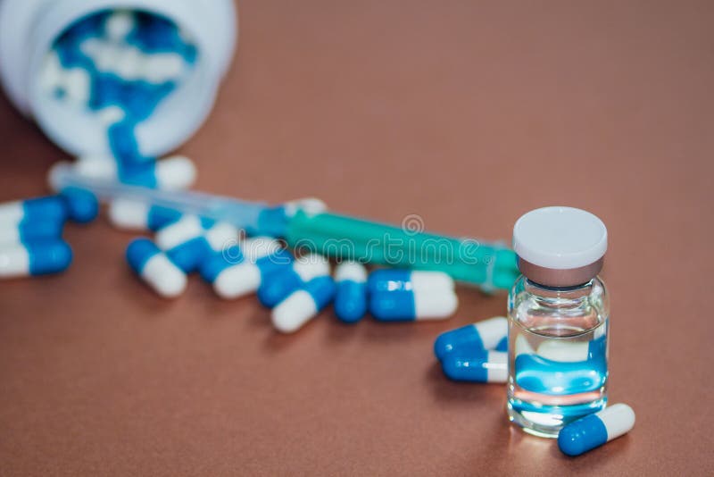 Closeup of Illegal Doping Injectable Drug and Capsules on a Table ...