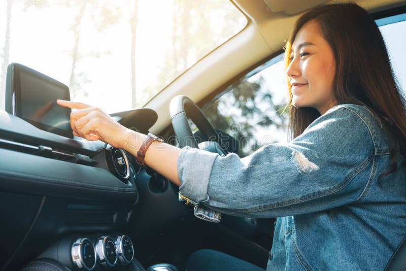 A Beautiful Woman Using and Pointing Finger at Navigation Screen while ...