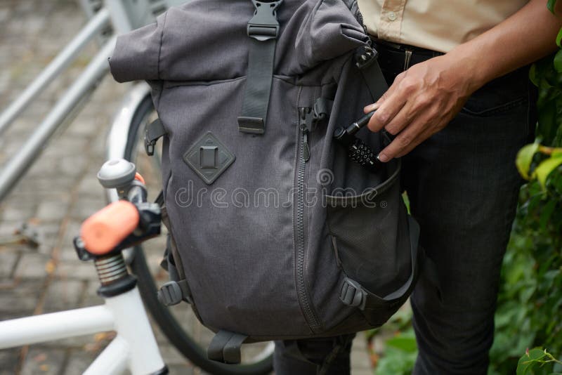 Bicycle Rider Putting Lock in Backpack Stock Image - Image of student ...