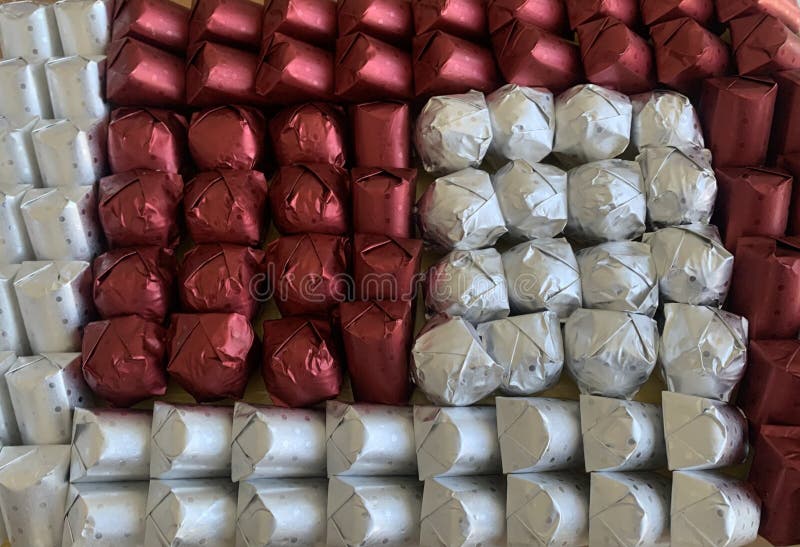 Closeup Image of a Box of Individually Wrapped Chocolates in Red and ...