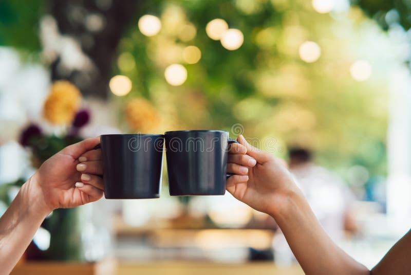 Closeup Image of a People Clinking Coffee Cups Together in Cafe Stock ...