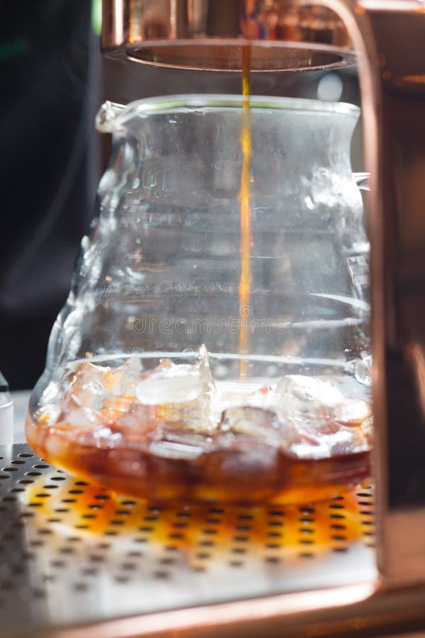 Hot Coffee Dropping into the Coffee Cup by Coffee Machine Stock Photo ...
