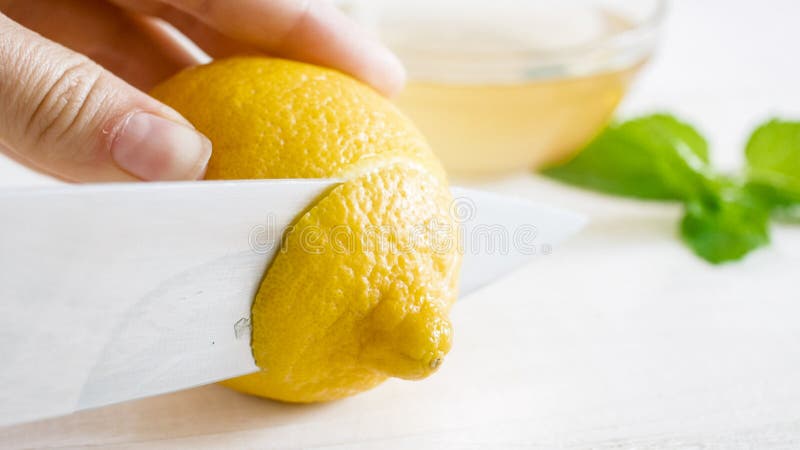 Closeup Image of Hand Cutting Fresh Lemon with Knife Stock Image ...