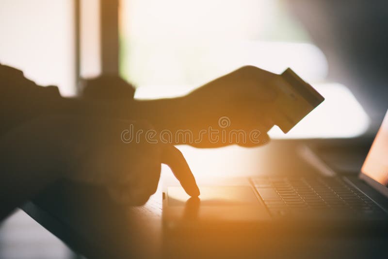 A Person Using Credit Card for Purchasing and Shopping Online on Laptop ...