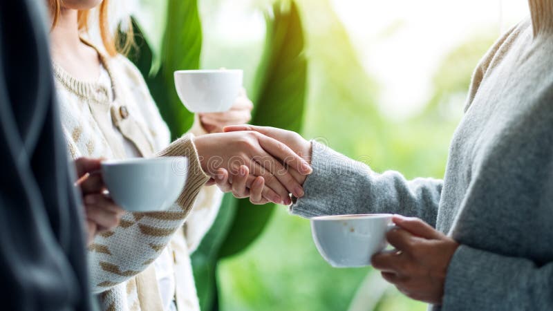 People Holding Hands while Drinking Coffee Together Stock Photo - Image ...