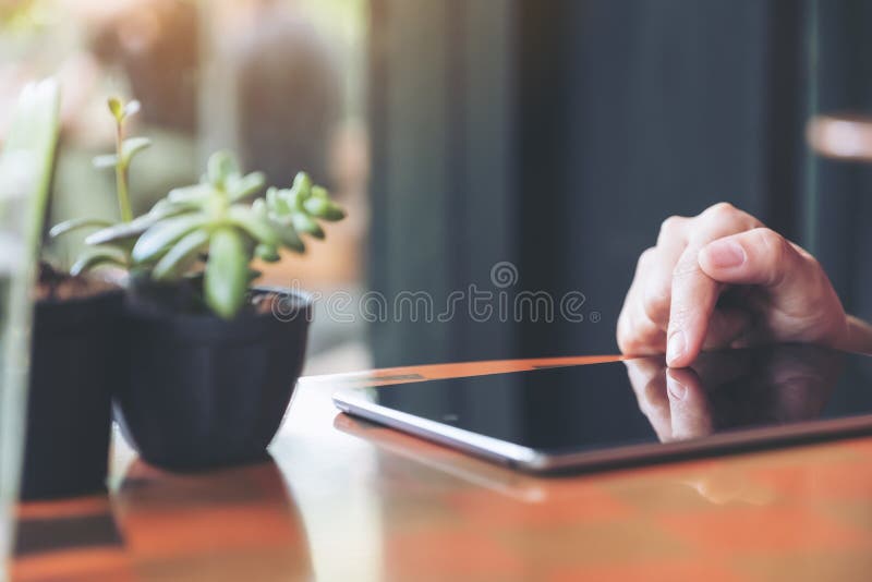 A Woman`s Hands Pointing , Touching and Using Tablet Pc with Tree Pot ...