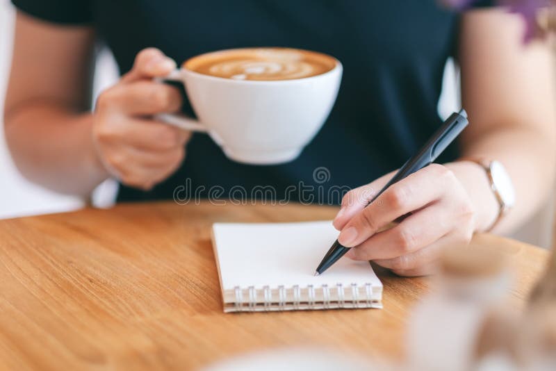 A Woman Writing on Blank Notebook while Drinking Coffee Stock Photo ...