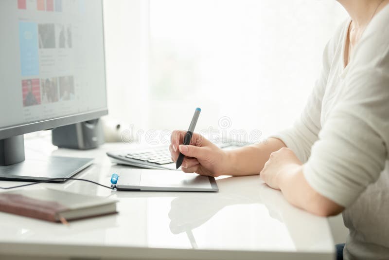 Closeup Image of Young Female Graphic Designer Holding Stylus and ... Closeup Image of Young Female Graphic Designer Holding Stylus and ...