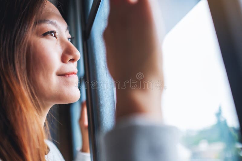 A Young Woman Touching on Window while Looking Outside Stock Photo ...