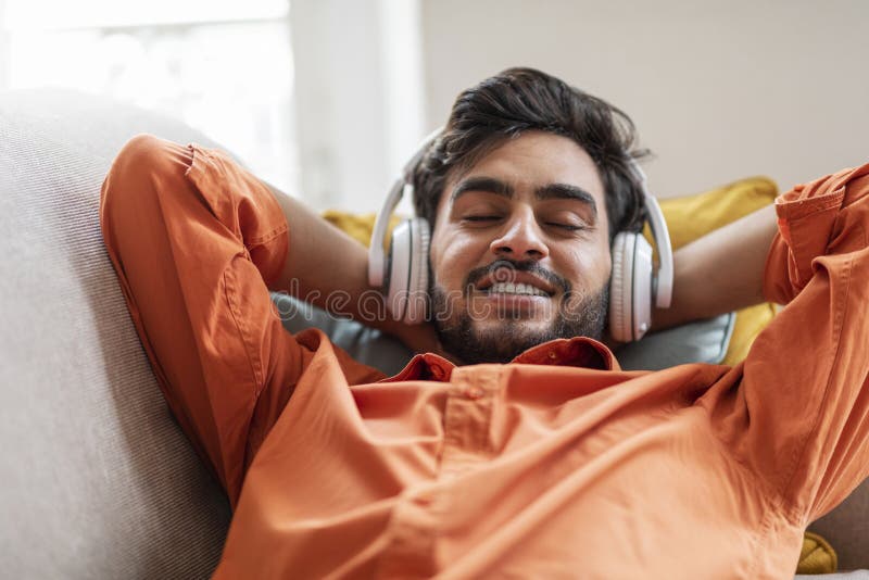 Closeup Joyful Middle Eastern Man Listening To Music At Home Stock