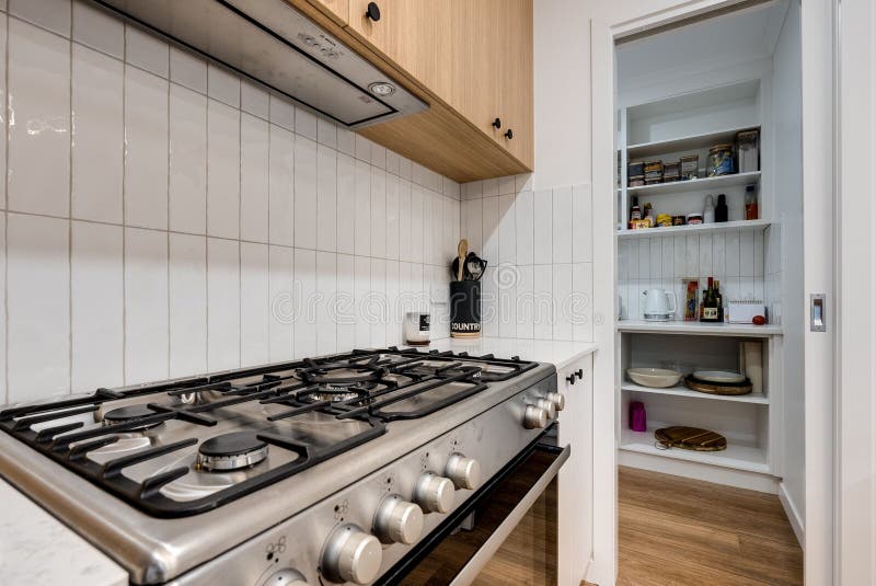 Closeup of a Kitchen Interior Displaying a Stove and an Open Storage ...