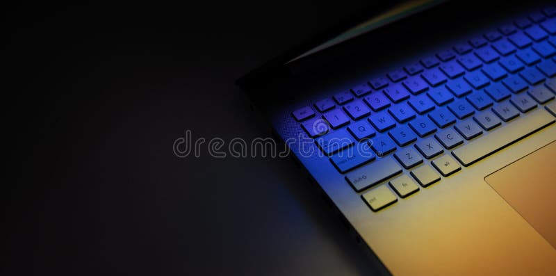 Laptop Computer Keyboard on Dark Table with Colorful Light Reflection ...