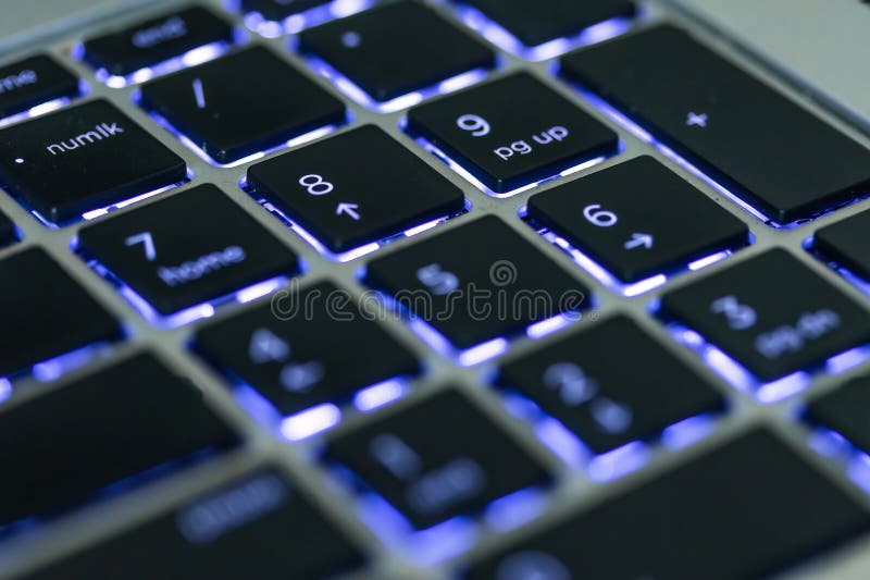 Closeup of Laptop Keyboard Number Pad Lit with Blue Lights Underneath ...