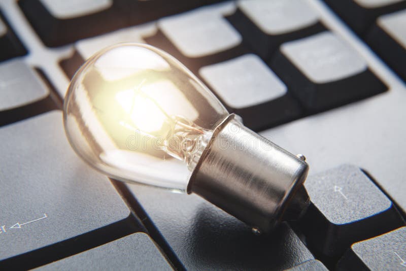 Closeup of Light Bulb on Computer Keyboard Stock Photo - Image of ...