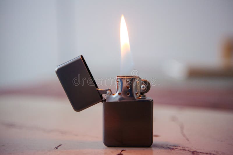 Lighter with Flame on Wooden Table Stock Image - Image of silver ...