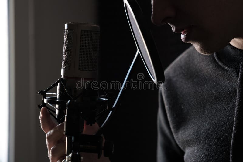Closeup of Lips and Hands on a Microphone of a Young Man Standing in ...