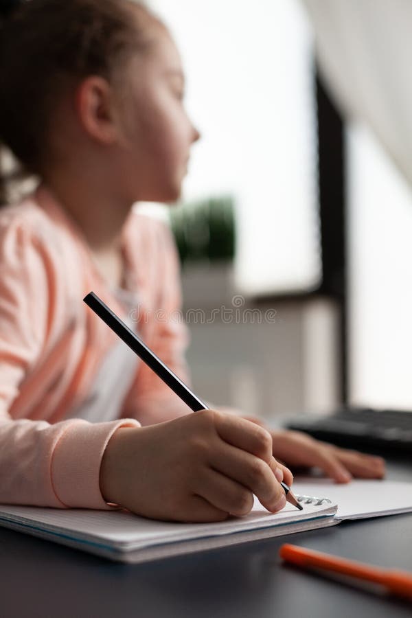 Closeup of Little Schoolkid Studying Online Lesson Writing Mathematics ...