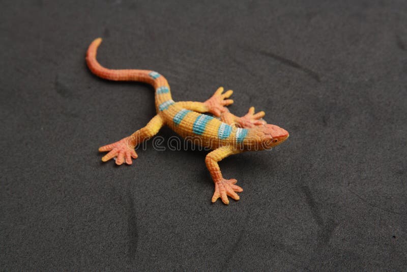 Closeup of a Lizard Shaped Rubber Toy on a Brown Surface Stock Image ...