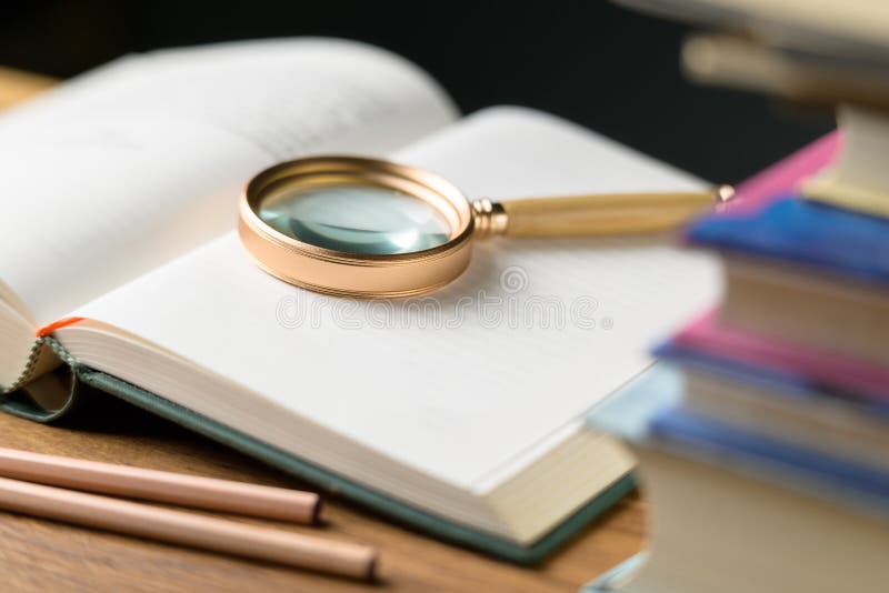 Magnifying Glass on the Opened Book on the Desk Stock Photo - Image of ...