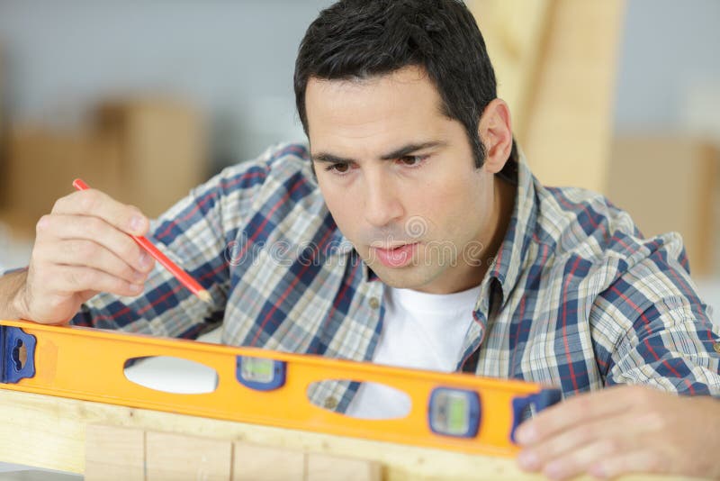 Closeup Male Carpenter Using Level on Wood Board Stock Image - Image of ...