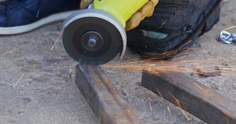 Closeup of the Man with an Angle Grinder Cutting the Metal Tube Pipe ...