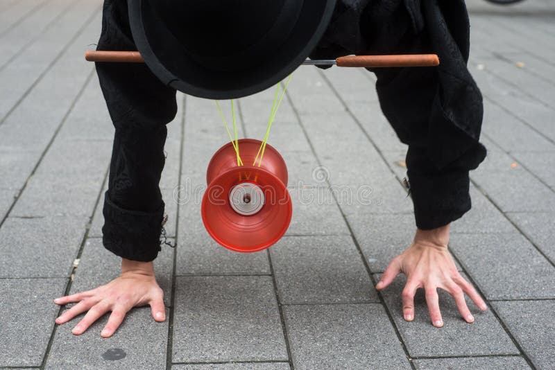 Man Balacing on Hands Playing with Diabolo in the Street Stock Photo ...