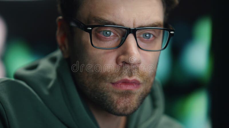 Closeup Man Coder Working Night Datacenter. Serious Developer Looking ... Closeup Man Coder Working Night Datacenter. Serious Developer Looking ...
