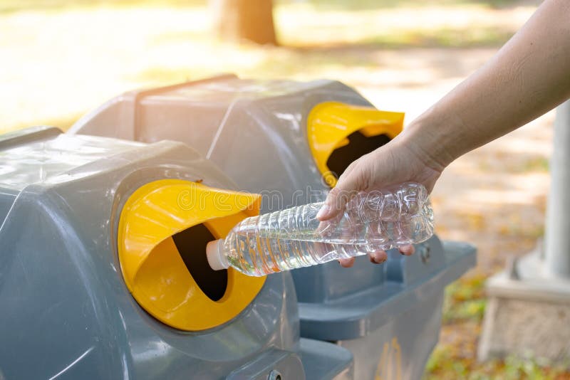 Closeup Man Hand Throwing Empty Plastic Water Bottle into the Trash ...