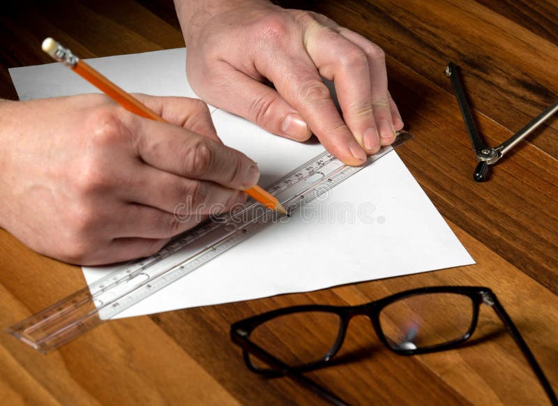 Closeup of Man Hands Holding Pencil and a Ruler. Working Environment on ...