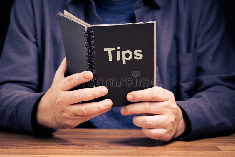 Reading the Tips Book stock photo. Image of education - 233180772