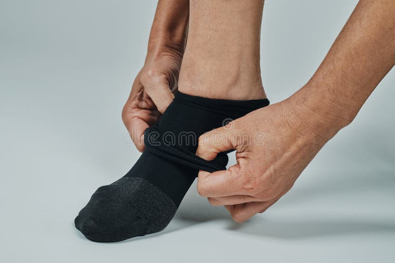 Man Putting on a Compression Sock Stock Image - Image of health, injury ...