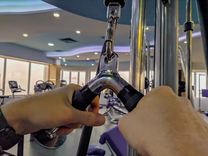Closeup of Man`s Hands Pulling Weight in a Modern Gym Interior while ...