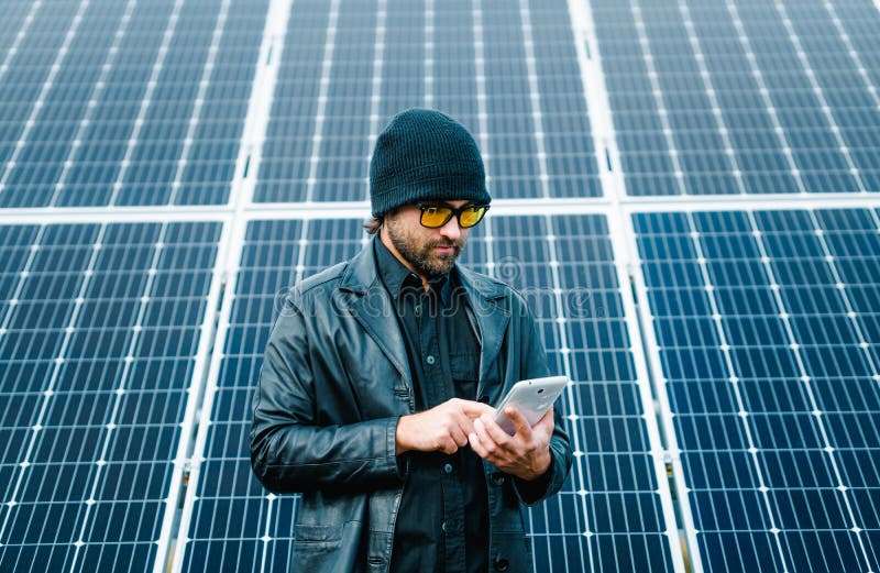 Closeup Man Stand beside of Solar Panels with Tablet in Hand and Make ...