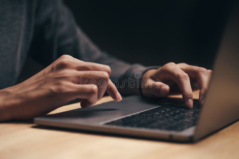 Closeup of a Man Using a Laptop Computer on the Wooden Table, Searching ...